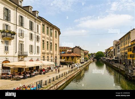 View Of The Naviglio Grande Waterway With People In An Outdoor