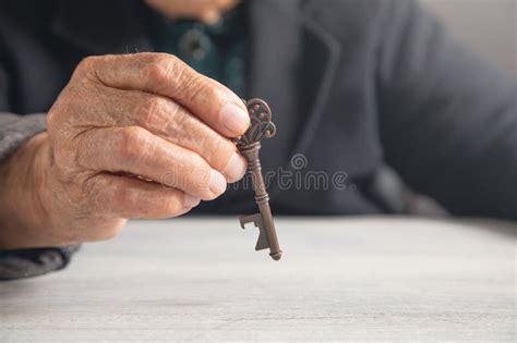 Elderly Female Hand With A Old Key Stock Image Image Of Retired