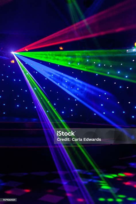 밝은 나이트 클럽 빨강 녹색 보라색 흰색 분홍색 파란색 레이저 조명이 연기 기계 연기를 절단하여 댄스 플로어에서 빛과 무지개 패턴을 만듭니다 배경에 보케가 있는 레이저 조명