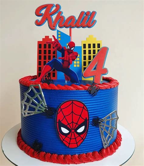 A Spiderman Birthday Cake With The Number Four On Its Top And Decorations