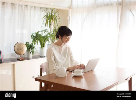 Asian Female Using Computer Hi Res Stock Photography And Images Alamy