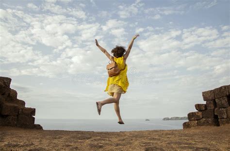 A Woman Jumping On The Edge Of A Cliff Stock Image Image Of Horizon