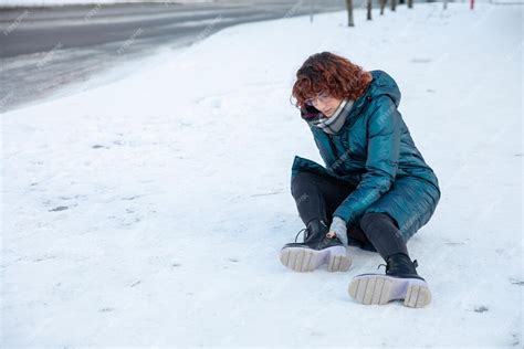 Premium Photo A Young Girl Fell In The Snow And Twisted Her Ankle