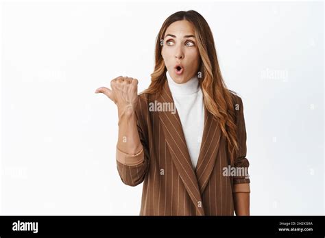 Business Concept Amazed Businesswoman Pointing And Looking Left