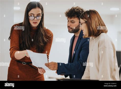 Diverse Team Working Late Analyzing Reports Brainstorming Growth Strategies Planning