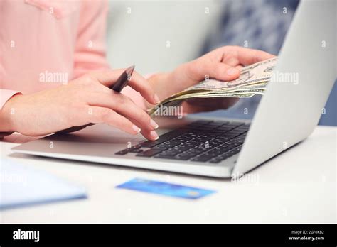 Woman Counting Money And Making Calculations Stock Photo Alamy