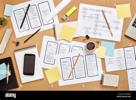 Top View Image Of Busy Web Ux Designers Workspace With Many Mobile App Wireframe Sketches And