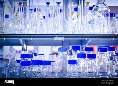 Glass Bottles And Jars Beakers And Test Tubes With Bright Blue Tops On