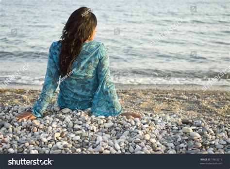Girl Sitting Alone On Beach