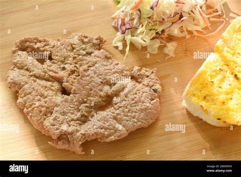 Grilled Black Pepper Pork Steak With Butter Garlic Bread And Salad On
