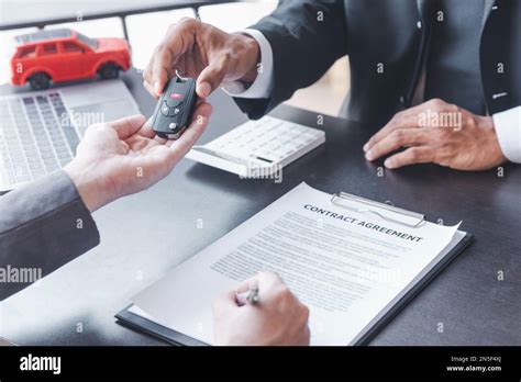 Concept Of Car Insurance Or Rental Salesman Is Making Deal With Buyer