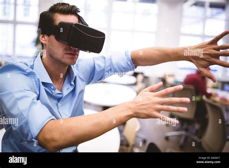 Executive Gesturing While Using Virtual Reality Glasses At Office Stock