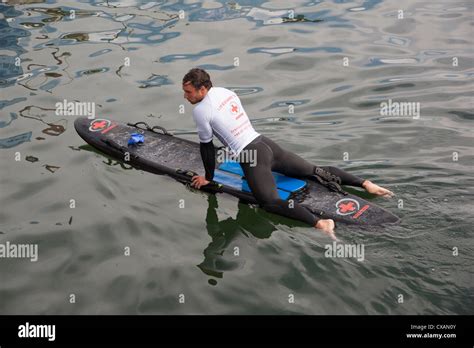 Lifeguard on a board Stock Photo - Alamy