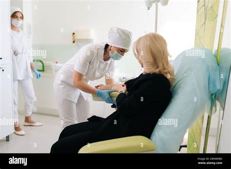 Side View Nurse In Medical Uniform Wiping With Cotton Wool Vein Where Inserting Needle With Iv