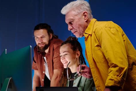 Premium Photo Team Of Programmers Gathered In Front Of Computer