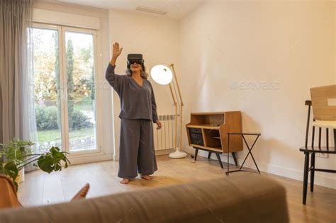 Mature Woman Gray Hair Glasses Virtual Reality Metaverse At Home Stock