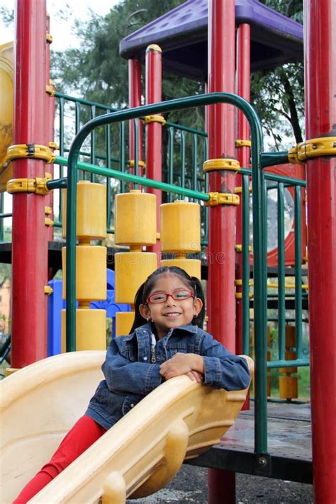 4 Year Old Latina Brunette Girl With Eye Glasses Plays In The Park