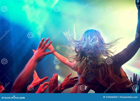 Crowd Surfing A Young Girl Crowd Surfing As A Band Plays One Of Her