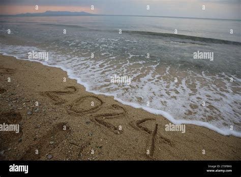 New Year 2024 Lettering On The Beach With Wave And Clear Blue Sea