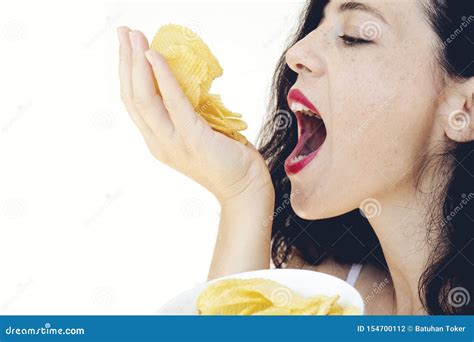 Hungry Attractive Girl Eats A Lot Of French Fries Holds A Handful Of