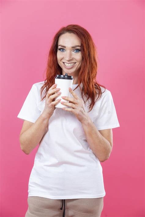 Winsome Female With Ginger Hair Using Disposable Cup Of Take Away