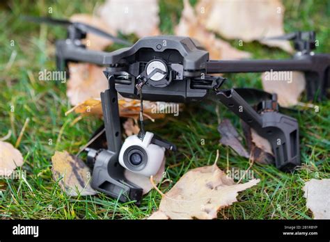 Broken Black Quadcopter Drone Uav Lying On Green Grass Lawn On Ground After Crash Accident