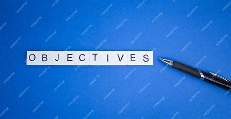 premium photo pen and alphabet letters with objective words objective