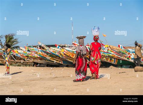 Woman At The Colorful Fishing Boats At The Beach In Tanji Gambia West