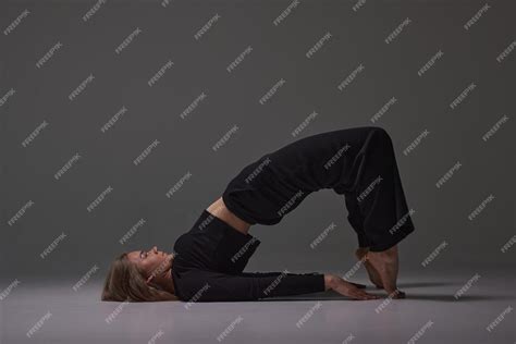 Premium Photo A Girl In Dark Clothes Dances And Jumps On A Dark