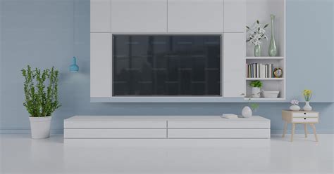 파란색 벽 배경에 있는 현대 거실의 캐비닛에 있는 Tv 3d 렌더링 사진 Unsplash의 개념 이미지