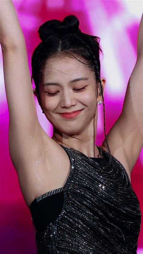 A Woman In A Black Dress Holding Her Arms Up With Both Hands And