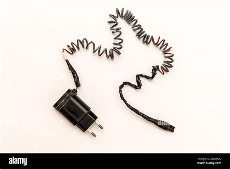 Charred Charger Wire Close Up White Background Flat Lay Short Circuited And Fire Concept