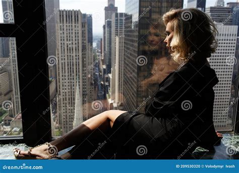 Woman In Black Silk Robe Lies With Naked Shoulders Before A Panoramic