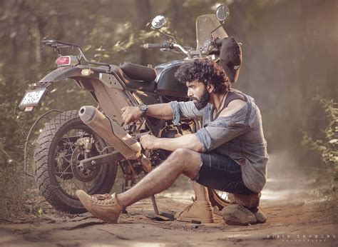 Download Man Fixing Himalayan Bike Wallpaper
