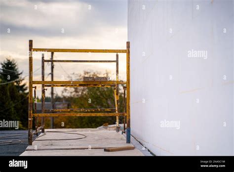 Scaffolding Stands Near The Wall Insulated With Polystyrene Foam