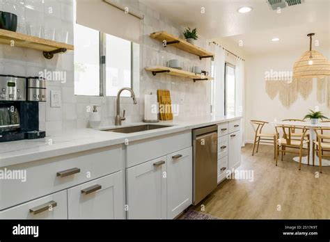 Modern Kitchen With White Cabinets Stainless Steel Appliances And