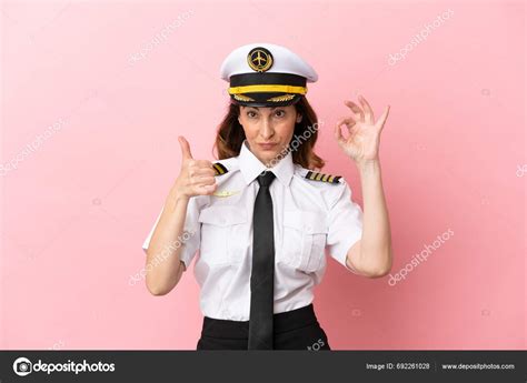 Airplane Middle Aged Pilot Woman Isolated Pink Background Showing Sign