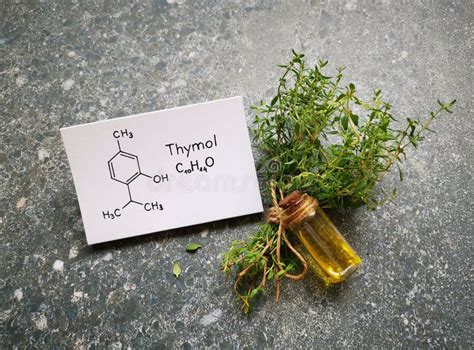 Thyme Essential Oil With Fresh Green Thyme Twigs And Chemical Formula
