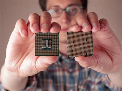 Hand Holding Cpu Modules To Assemble A Computer Choosing The Right