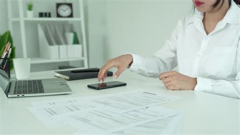 Business Woman Using A Mobile Phone Scan Barcode And QR Code The Businesswoman Is Checking The