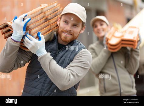 Bricklayer Industrial Workers Carrying Bricks At Construction Site