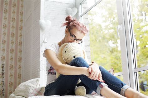 Low Angle View Of Timid Shy 15 Year Old Teenage Girl With Pinkish Hair