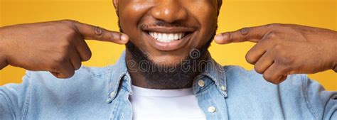Closeup Of Handsome Black Guy Smiling And Showing Perfect Teeth Stock
