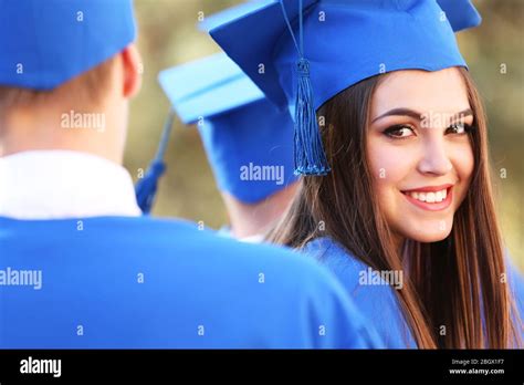 Graduate Babes Wearing Graduation Hat And Gown Outdoors Stock Photo Alamy