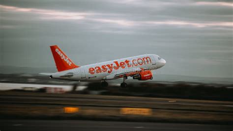 Easyjet Airplane A320 Taking Off At Sunset In John Lennon Airport