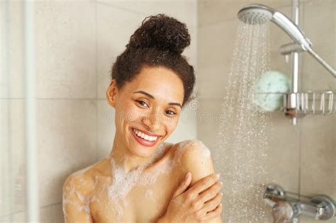 The Woman Is Showering And Smiling In The Bathroom Enjoying The Event