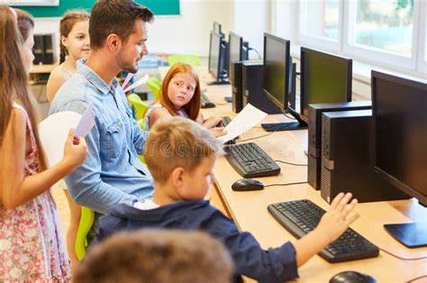Teacher Teaching Coding To Students In Computer Class Stock Image
