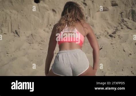 Female With Beautiful Body Dancing Twerk On The Sand Girl Moves Her Butt Standing Outdoors