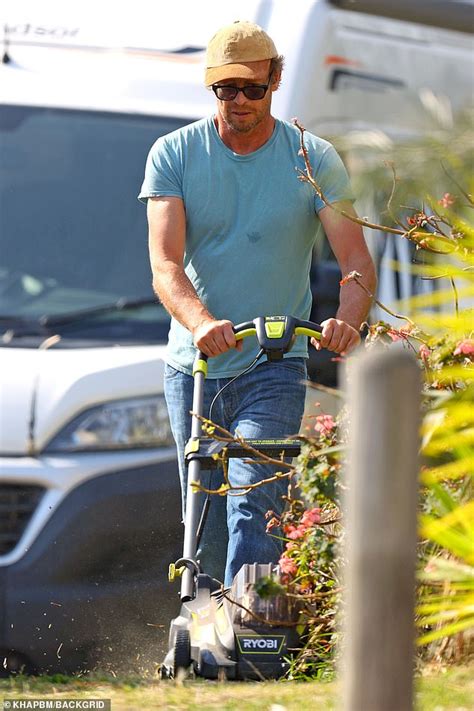 Simon Baker Works Up A Sweat As The Actor Mows The Lawn In A Muscle