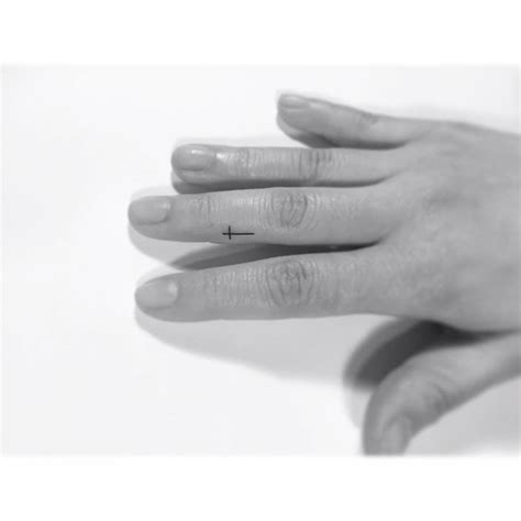 Tiny Cross Tattoo Done On The Finger Minimalistic